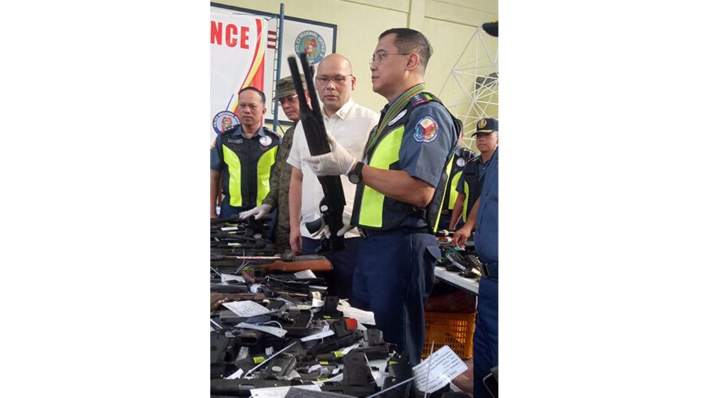 PNP OIC Lt. Gen. Archie Gamboa shows to media one of the firearms ...
